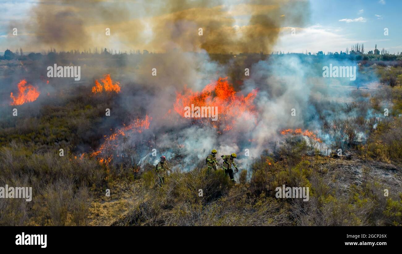 Aerial view of the brave firefighters put out the fire in a forest ...
