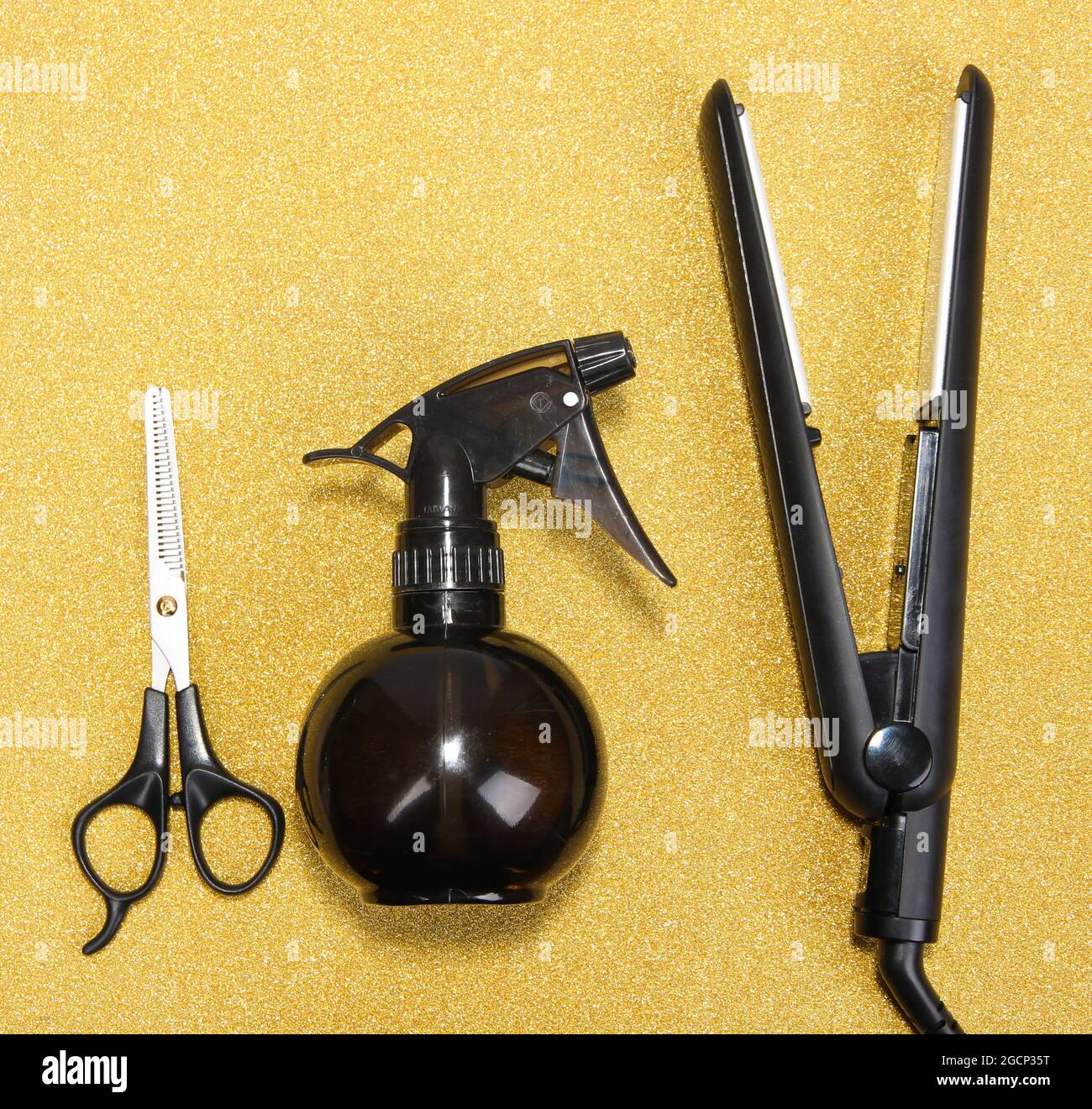Hairdressing tools on golden background Stock Photo - Alamy