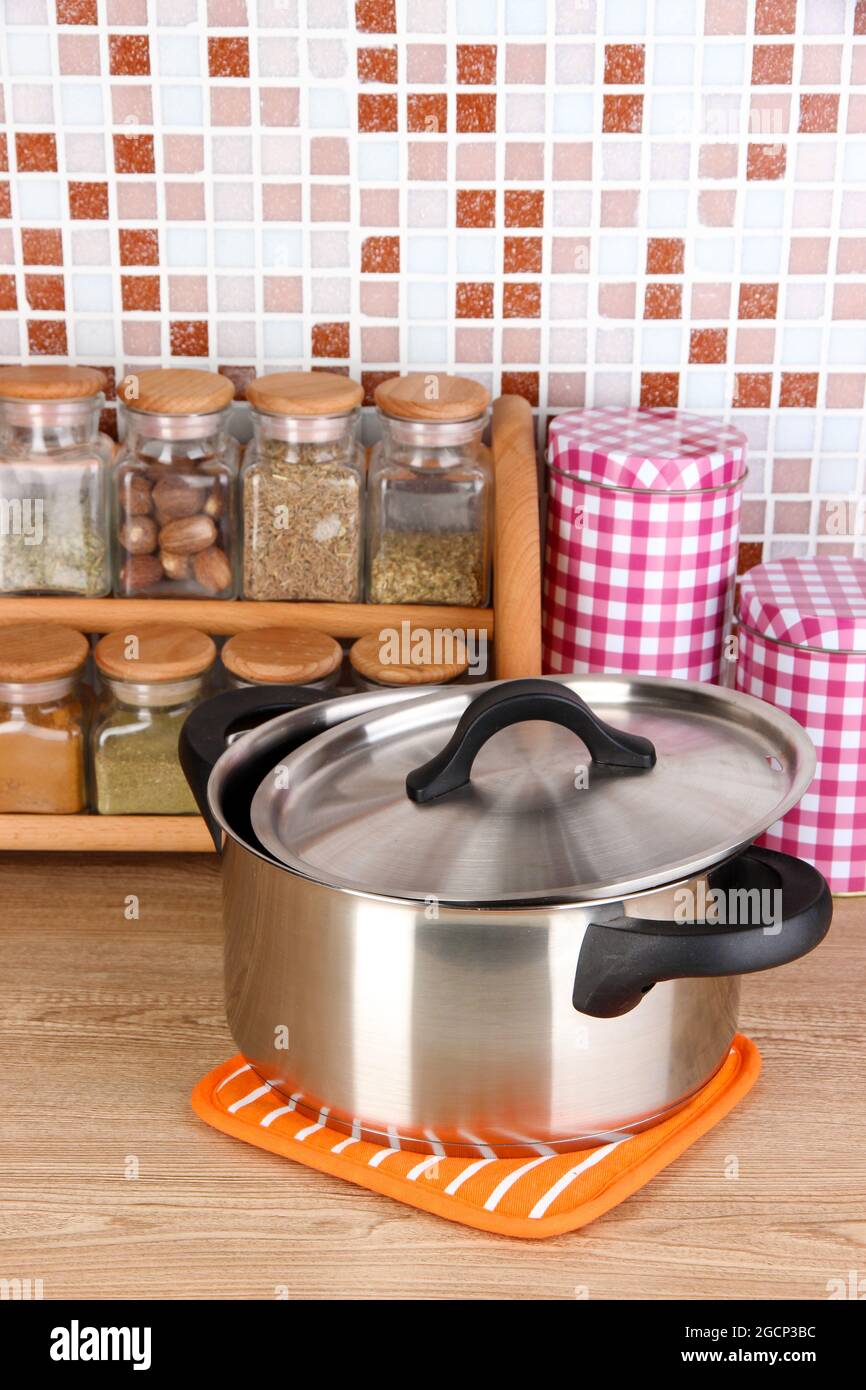 Pot and spices in kitchen on table on mosaic tiles background Stock ...