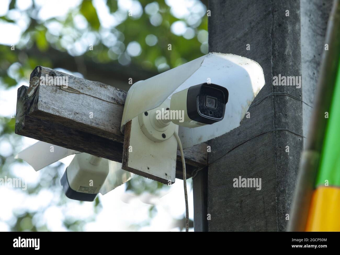 two white CCTV cameras mounted on a pole Stock Photo - Alamy