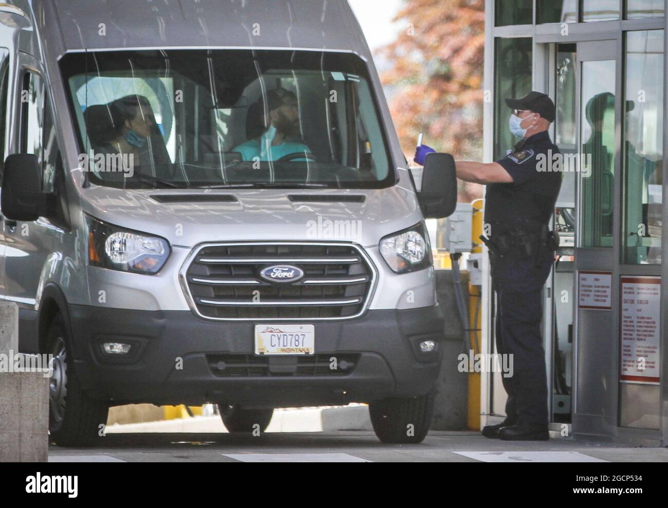 Surrey, Canada. 9th Aug, 2021. A Canadian border officer takes photo ...