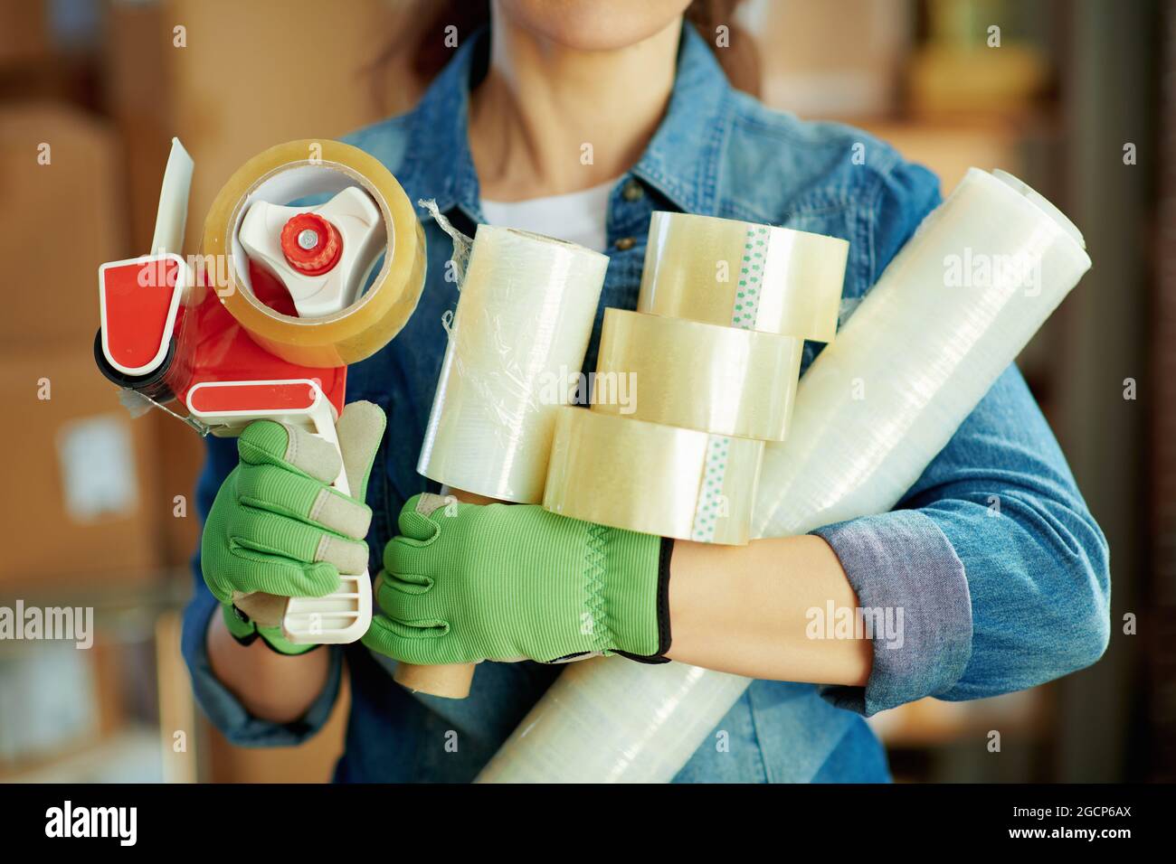 Delivery business. Closeup on female with packing tape dispenser ...