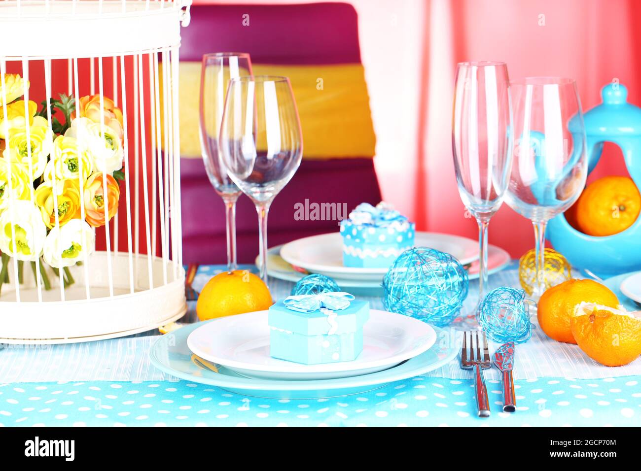 Table serving with colorful tableware on room background Stock Photo ...