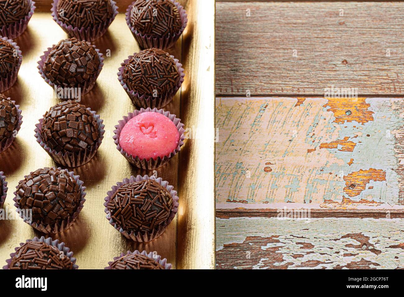 Strawberry Brigadeiro (Bicho de pe) surrounded by traditional ...