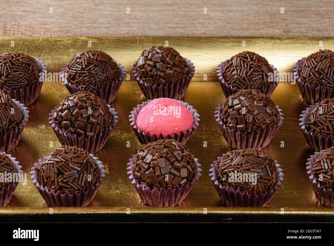 Strawberry Brigadeiro (Bicho de pe) surrounded by traditional ...
