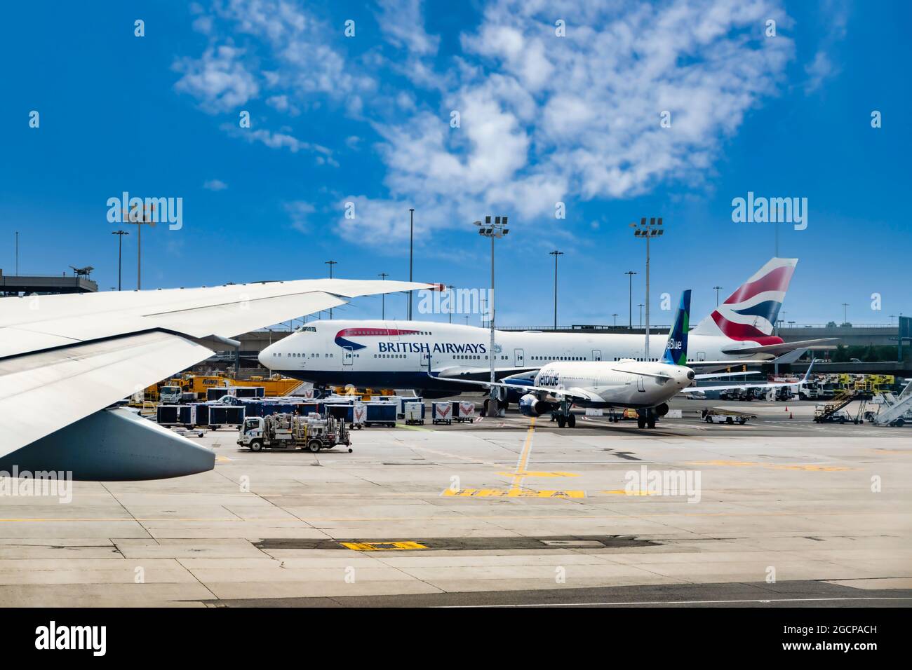A British Airways 747 and a JetBlue plane parked on the tarmac at John ...