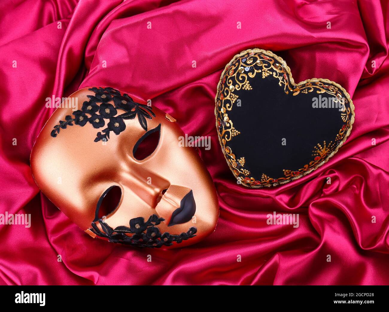 Decorative black heart and mask, on color fabric Stock Photo - Alamy