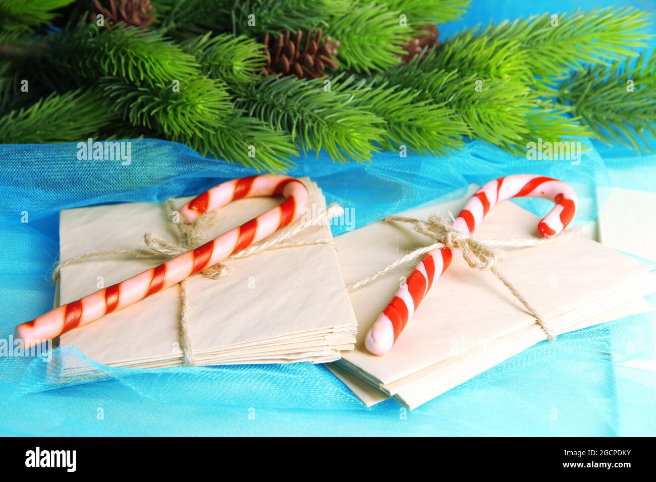 Christmas candy canes and letters for Santa, on color wooden background ...