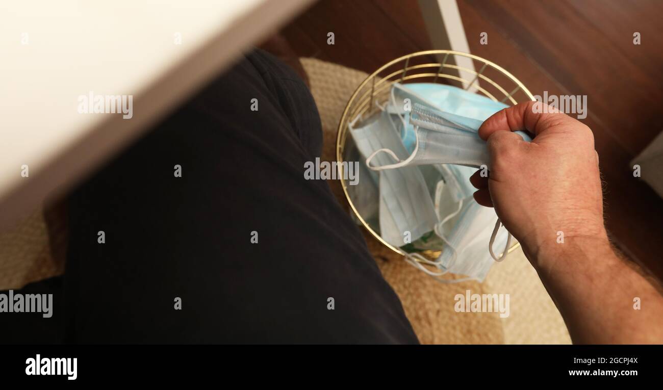 Putting face mask in bin hi-res stock photography and images - Alamy