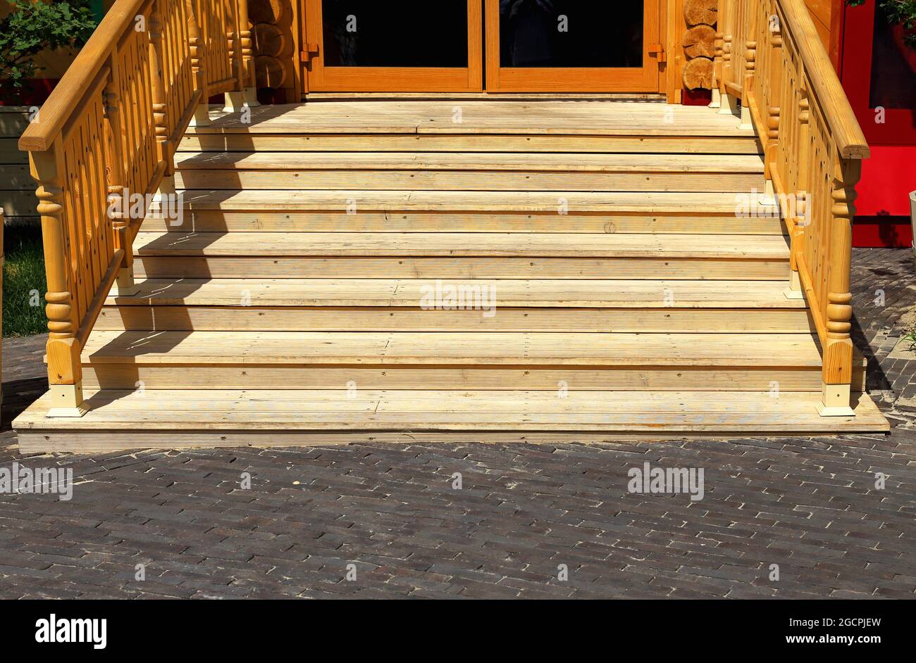 Detail of a wooden porch - steps and rails Stock Photo - Alamy