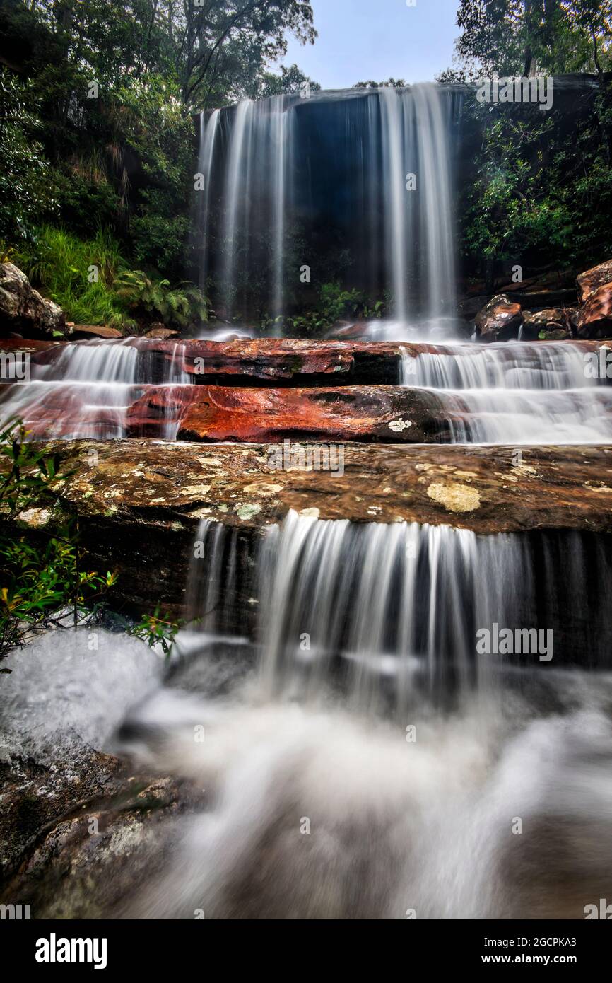 a large waterfall over some water at patonga Stock Photo - Alamy