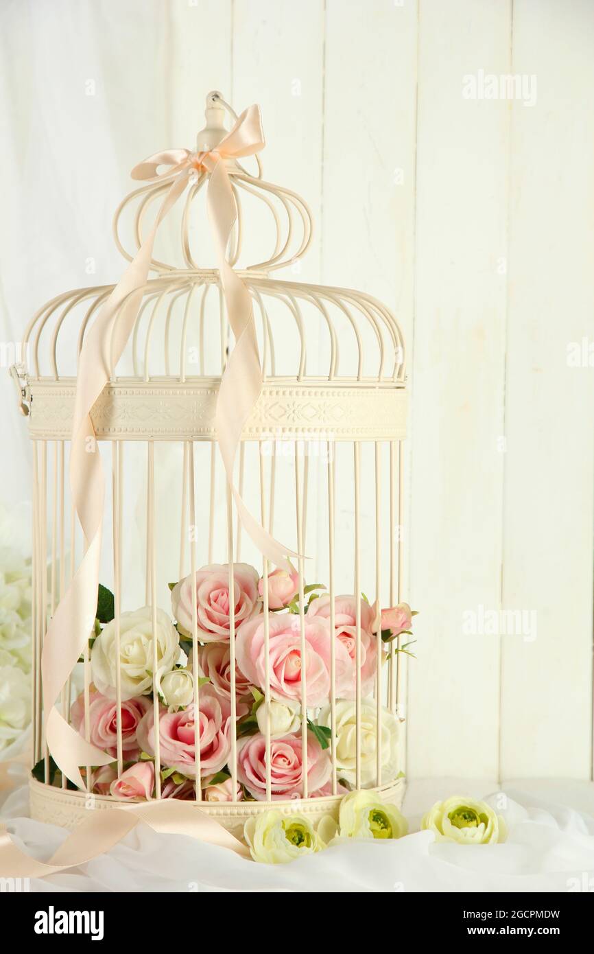 Beautiful decorative cage with beautiful flowers Stock Photo - Alamy