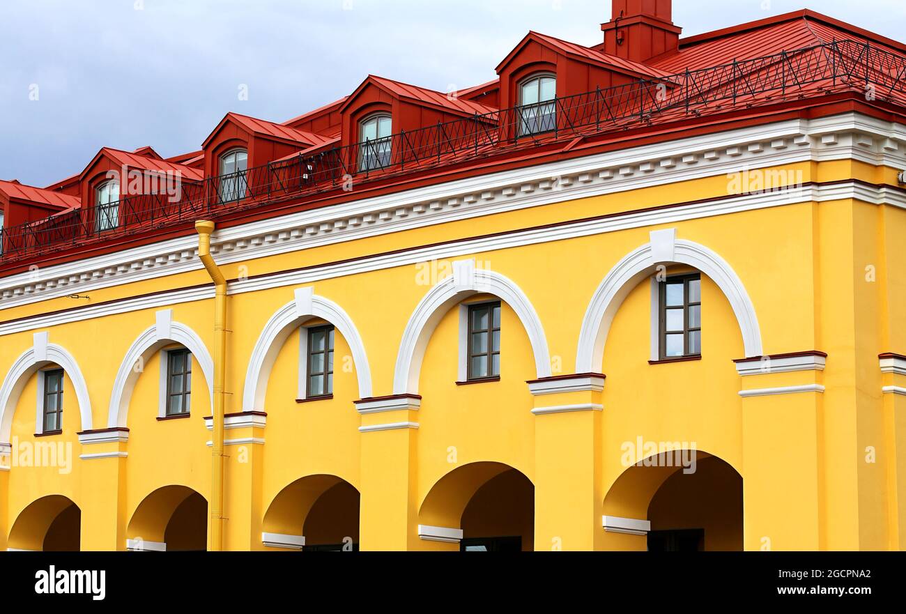 Windows under white decorative false arches on the yellow wall of a ...