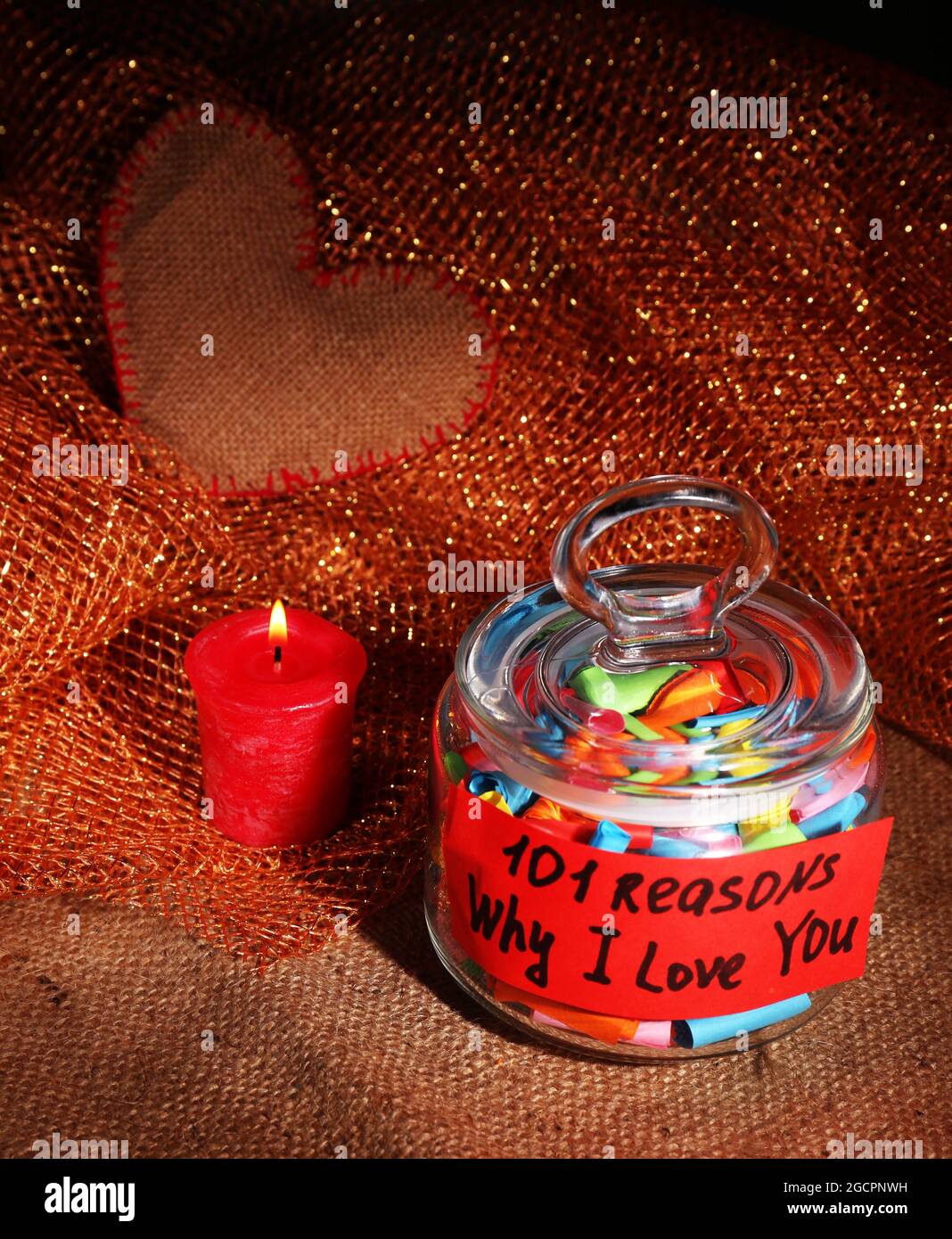 Dreams written on color rolled paper in glass jar, on sackcloth and ...