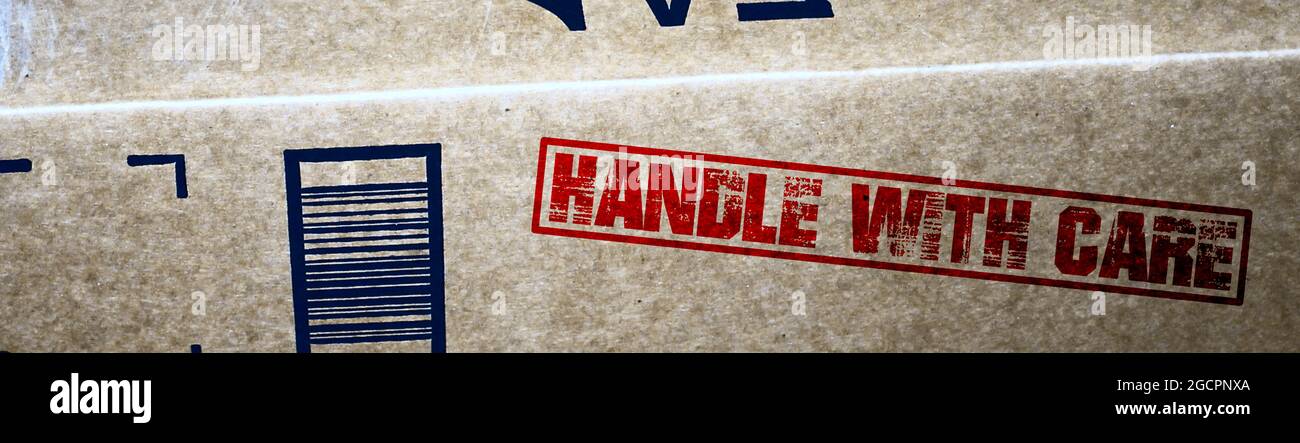 A package and note Handle with care Stock Photo - Alamy