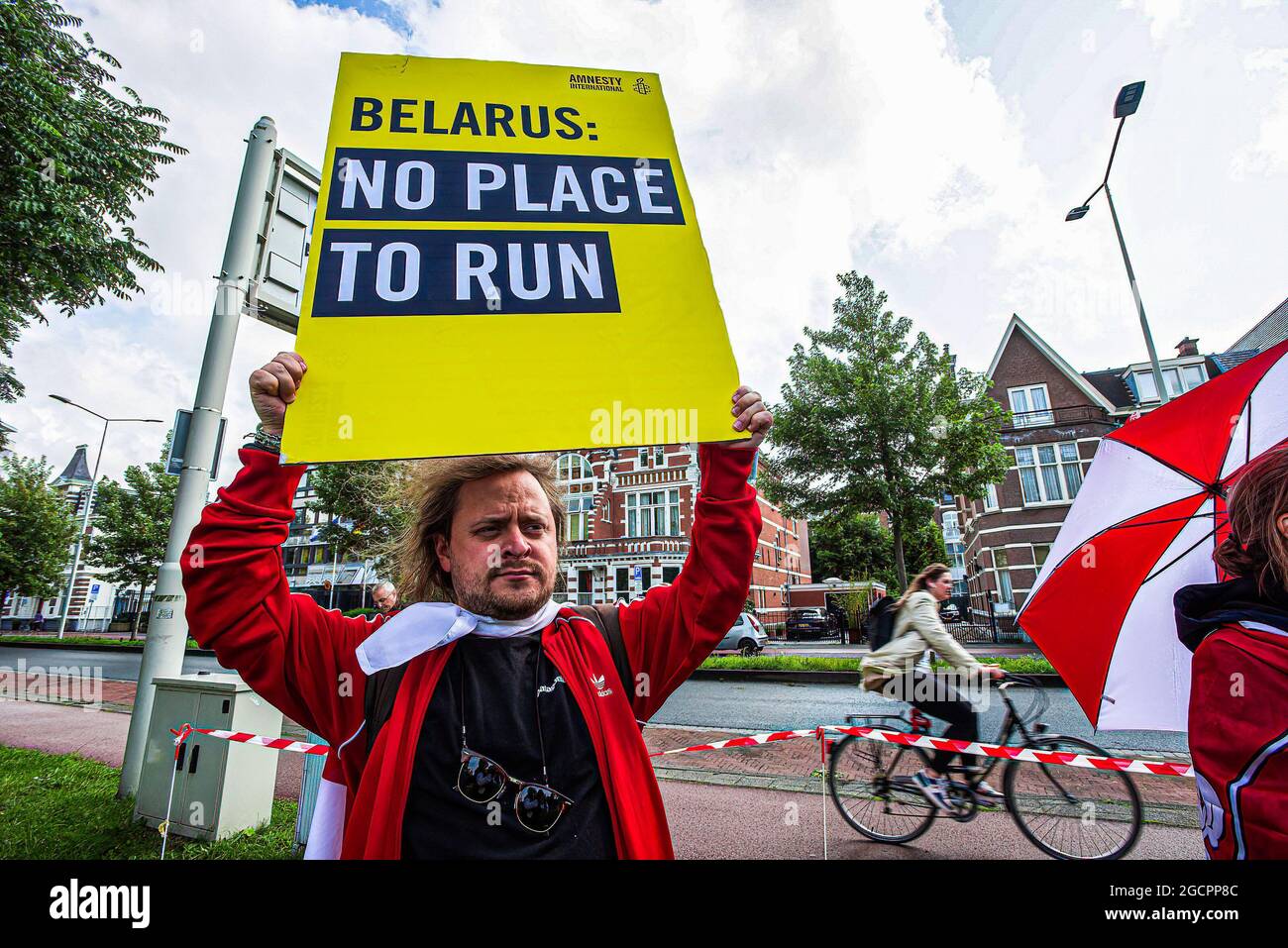 A protester carries a placard denouncing the Lukashenko regime during ...