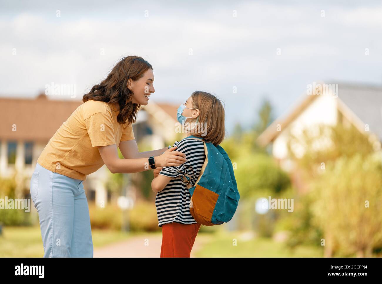 Parent and pupil of secondary school going hand in hand. Woman and girl ...