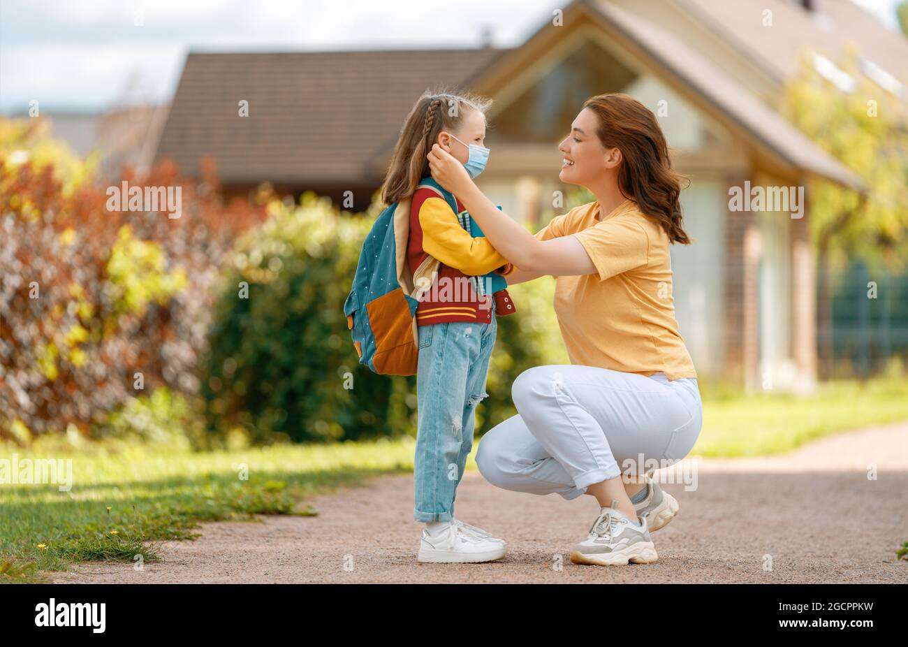 Parent and pupil of secondary school going hand in hand. Woman and girl ...