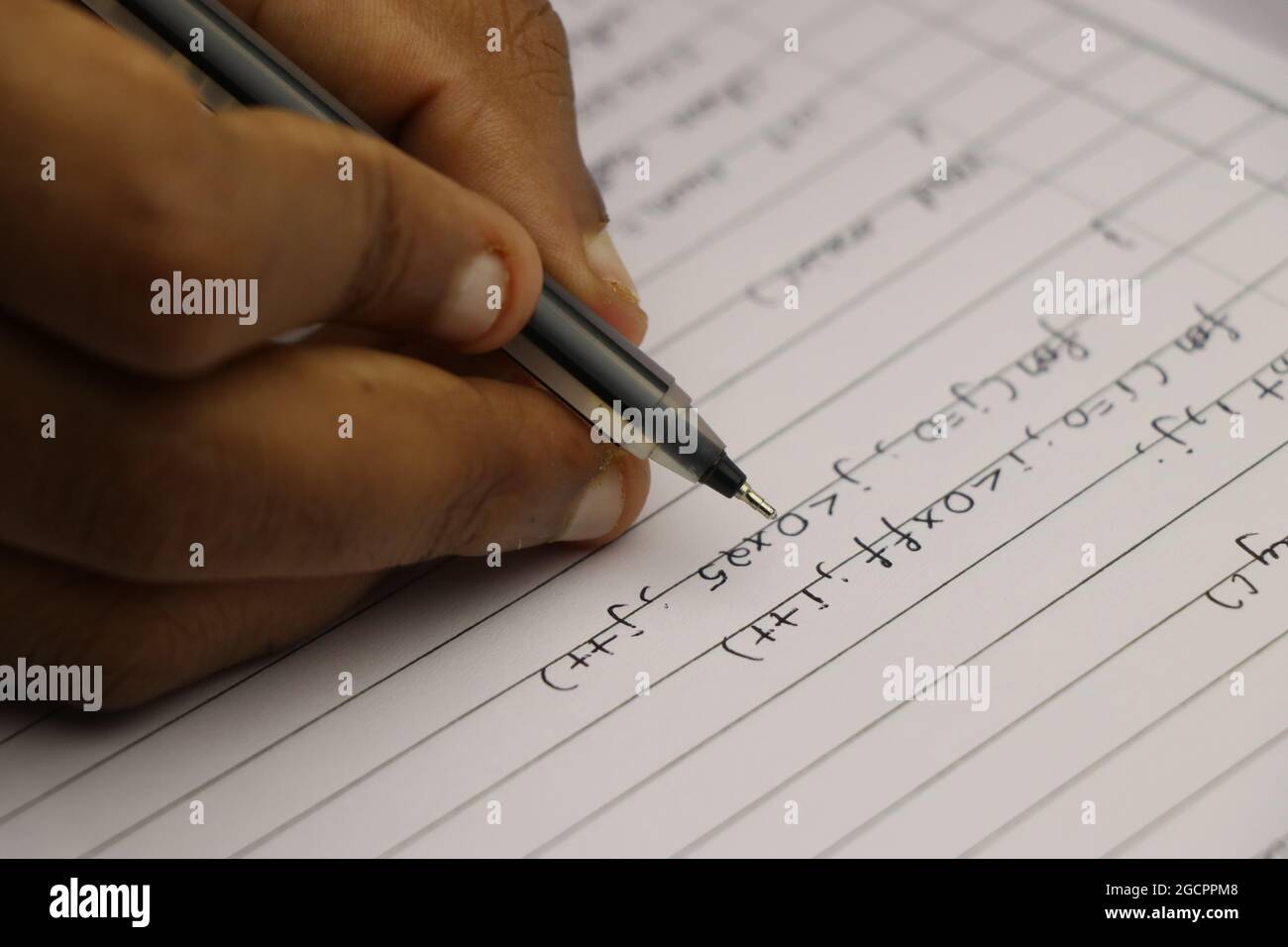 Hand of student writing computer programs on paper with black pen Stock ...