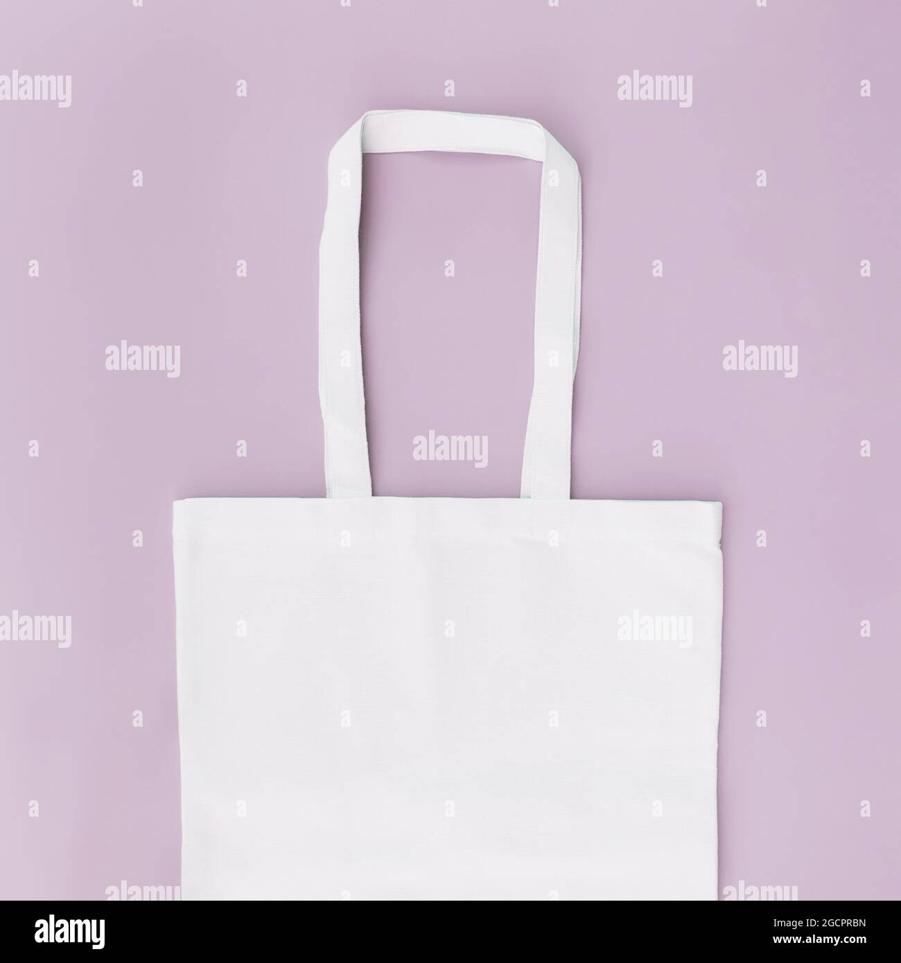 Eco white craft paper bag flat lay on pink background with copy space ...