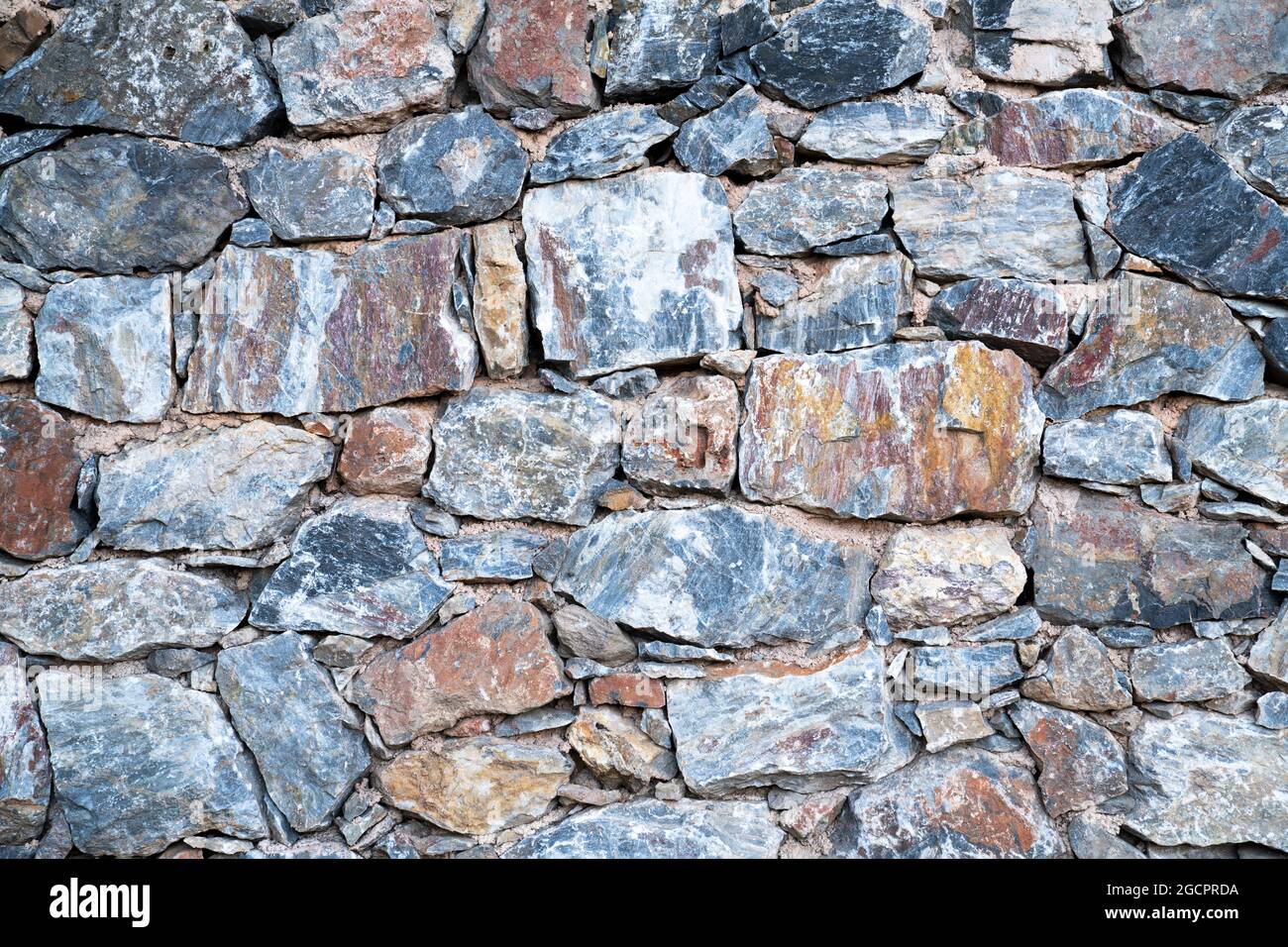 Texture of the masonry. Background of the surface of colored stones of ...