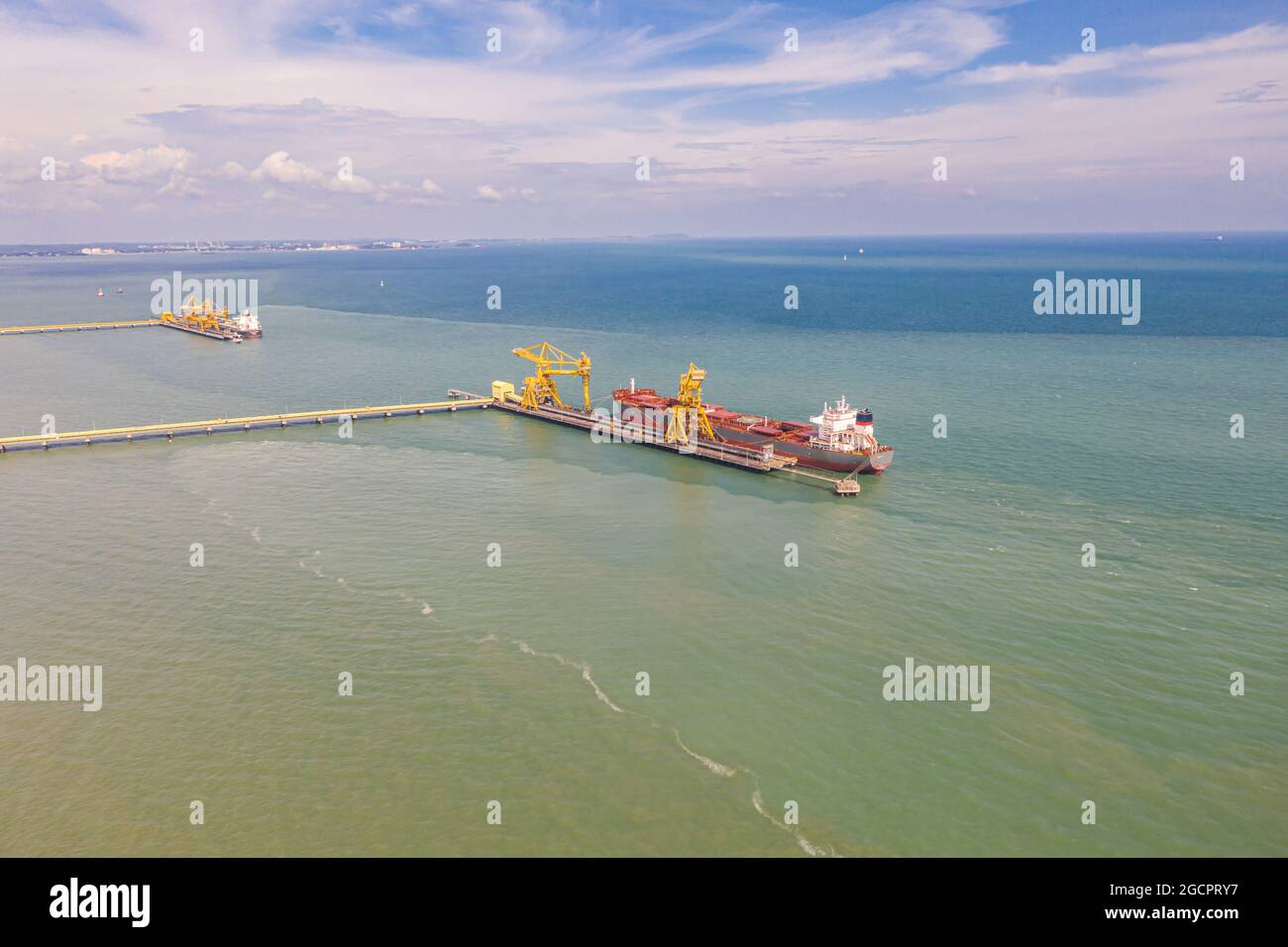 A coal transport ship at the dock of the Jimah Power Plant at the ...