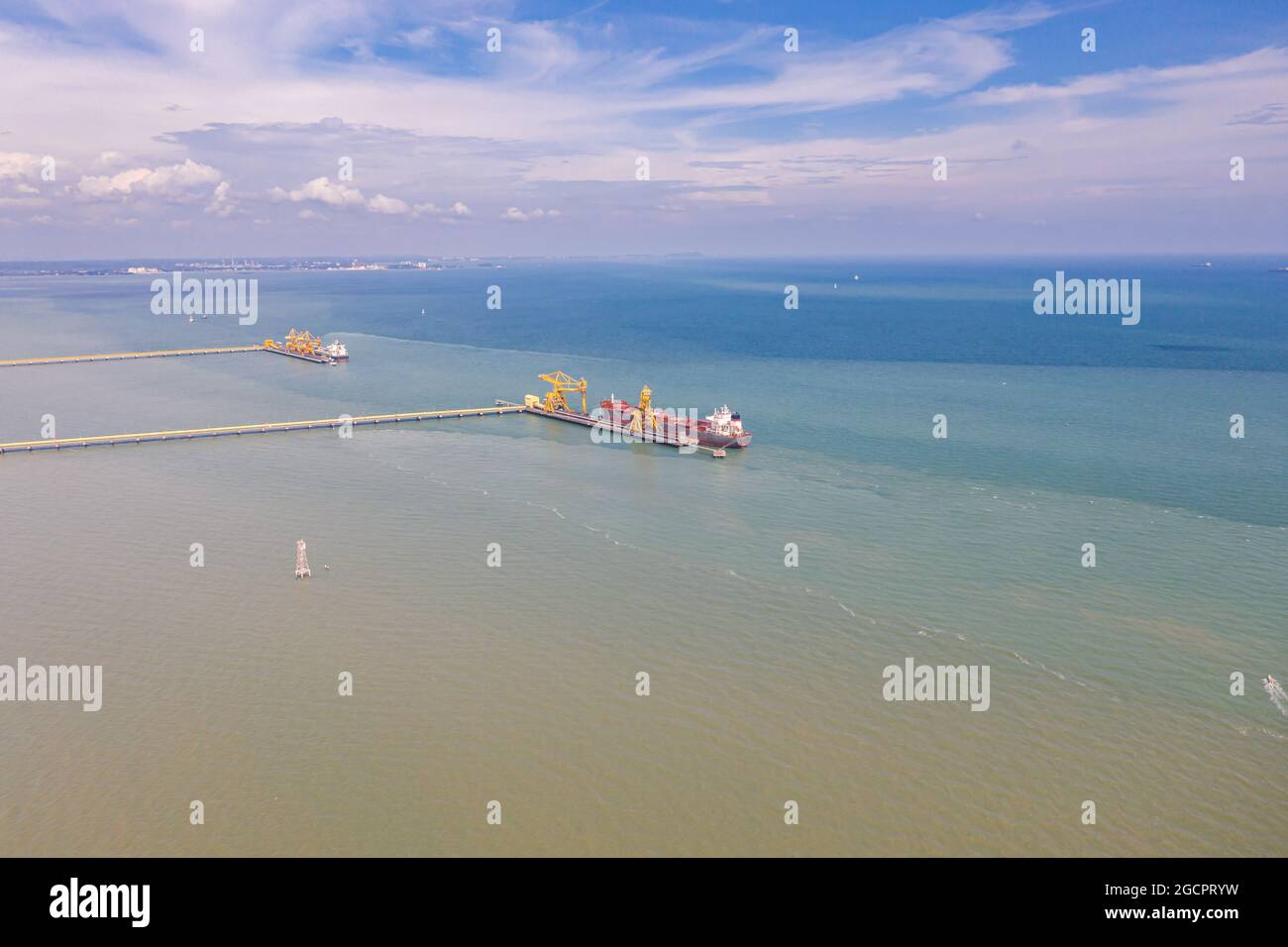 A coal transport ship at the dock of the Jimah Power Plant at the ...