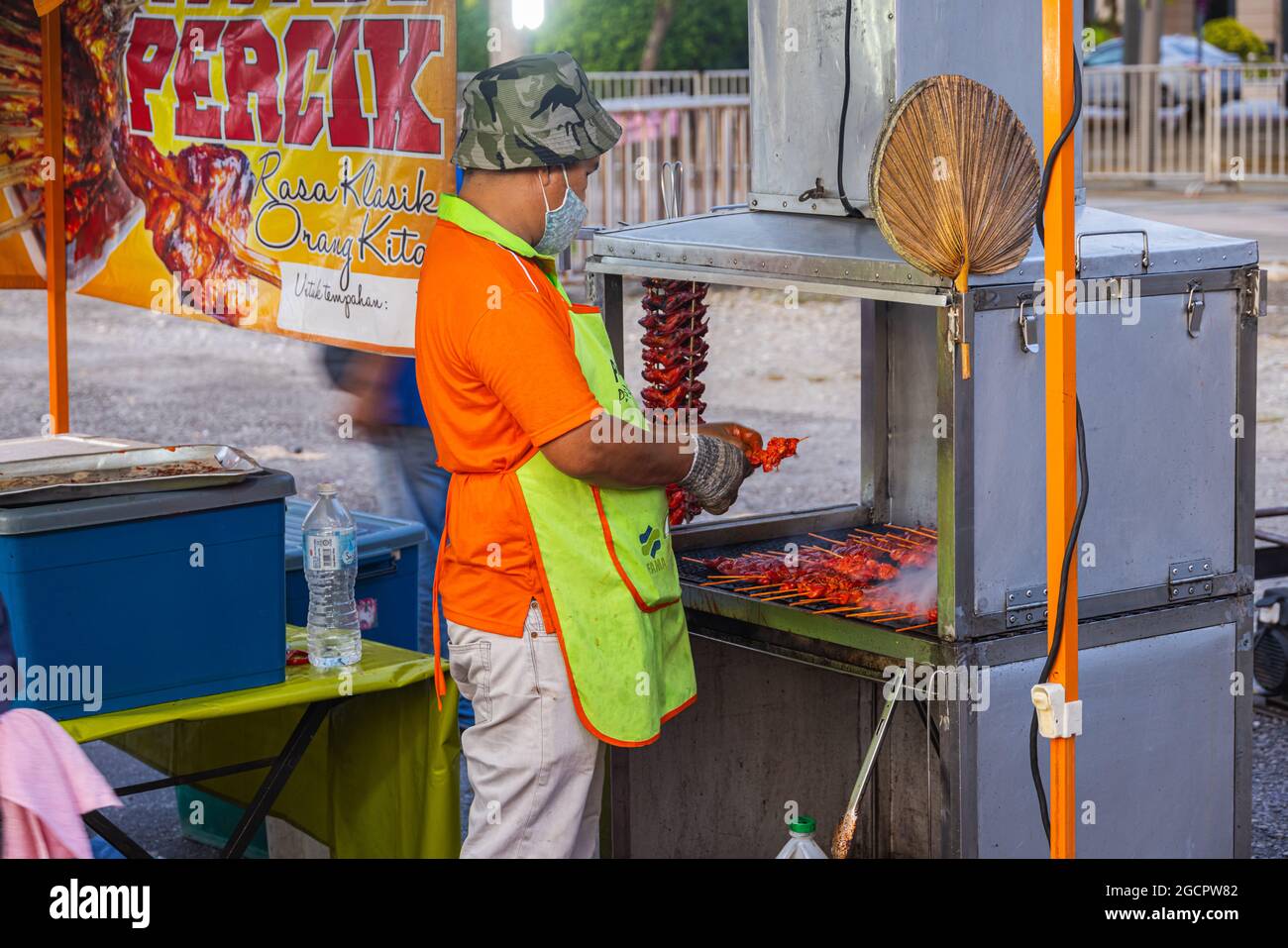 Honey chicken shop on the night market at Putrajaya, Kuala Lumpur. Man ...
