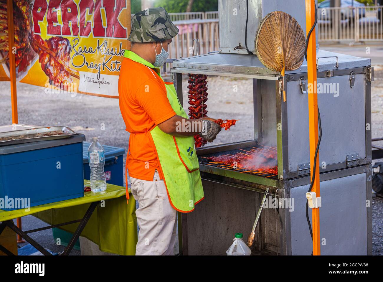 Honey chicken shop on the night market at Putrajaya, Kuala Lumpur. Man ...