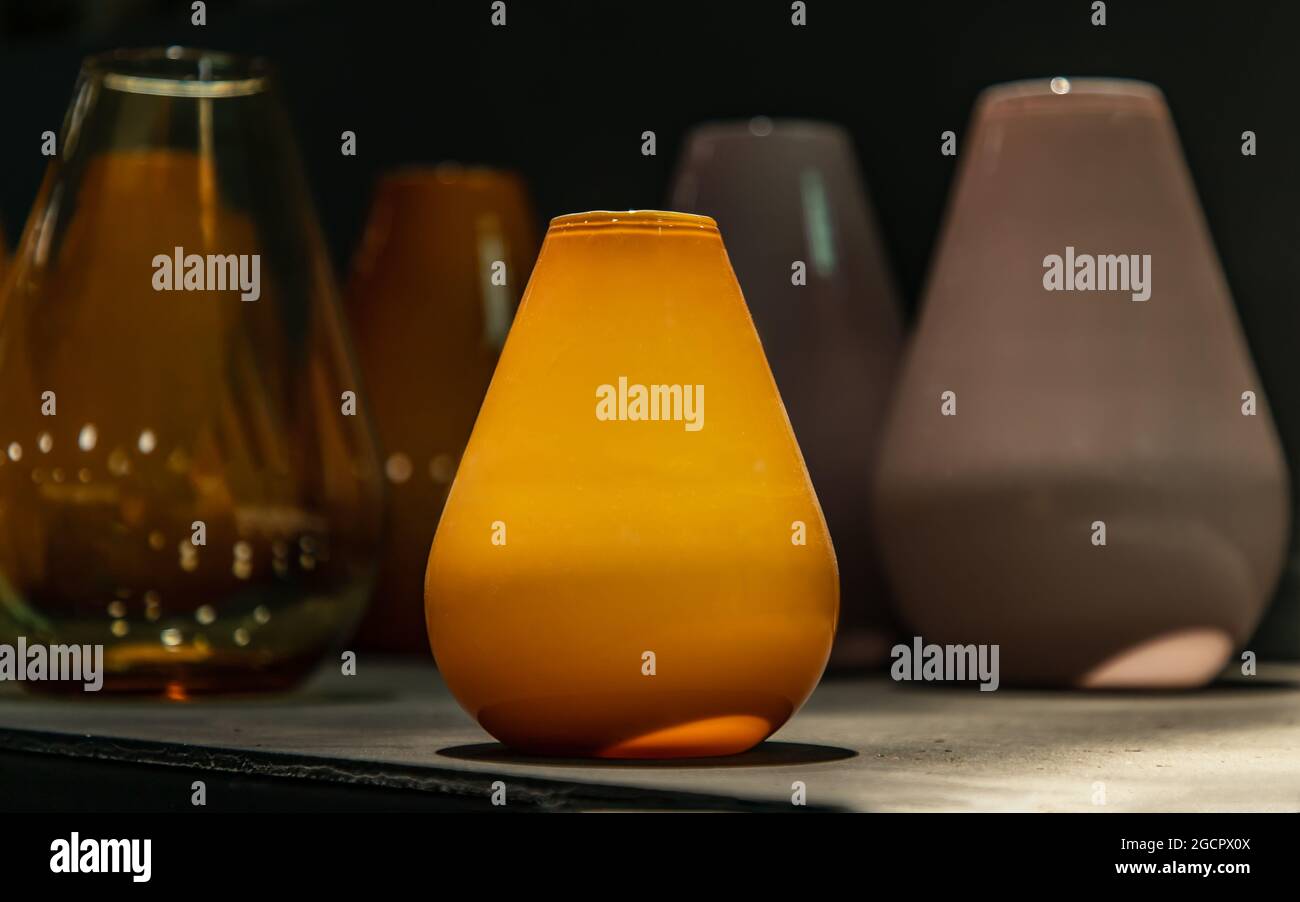 A display of yellow glass vases on the shelf at Glassware warehouse ...