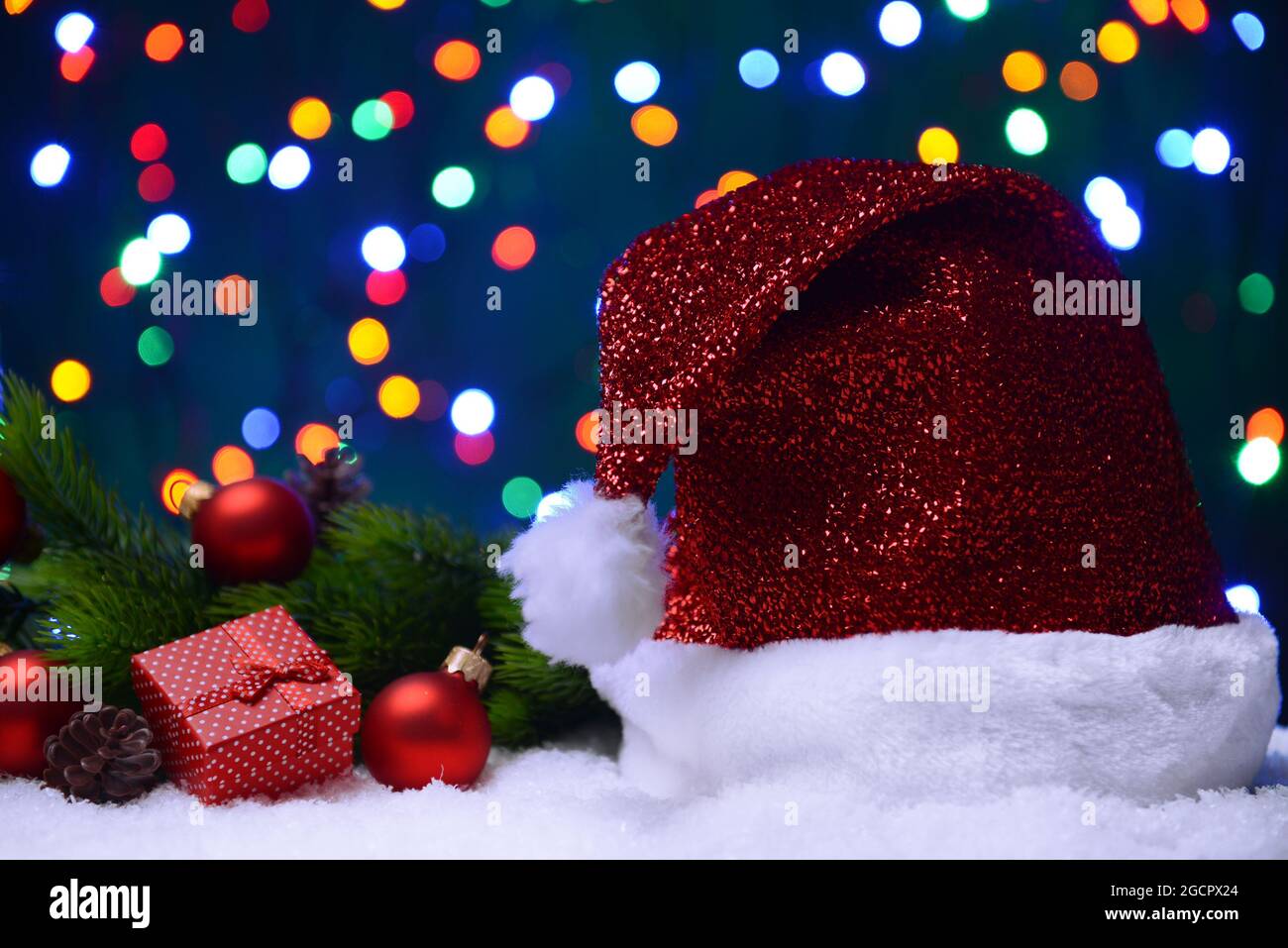 Santa hat on snow on lights background Stock Photo - Alamy