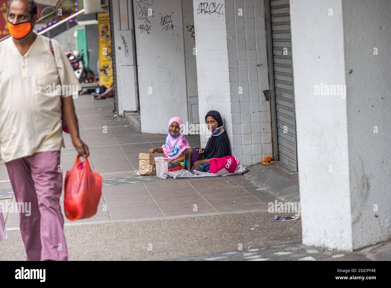 Kuala Lumpur, Malaysia - October 04, 2020: Street kids on the back ...
