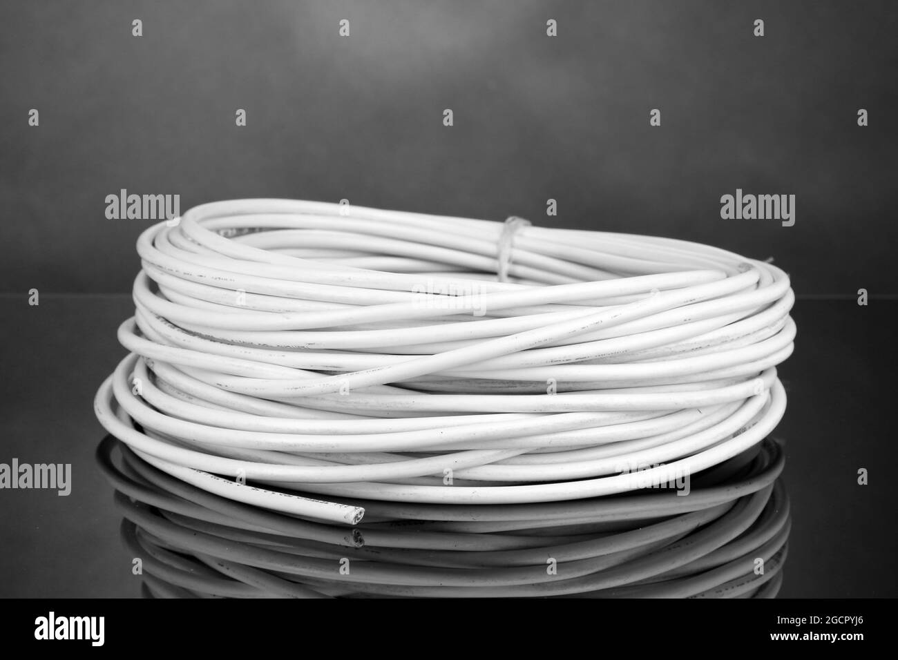 White cable on grey background Stock Photo - Alamy