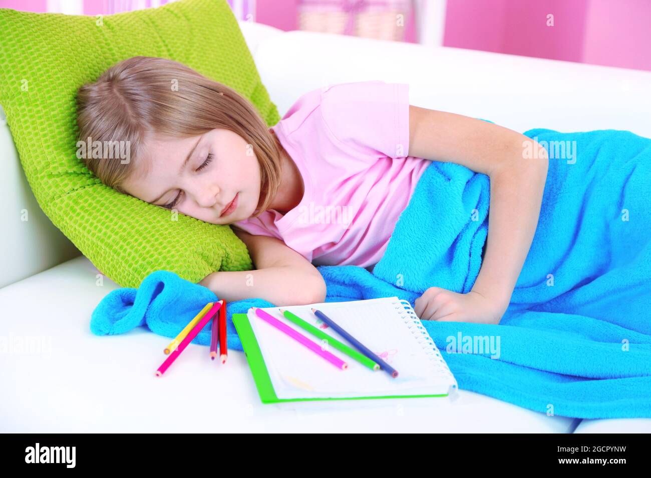 Little girl sleeping on sofa in room Stock Photo - Alamy