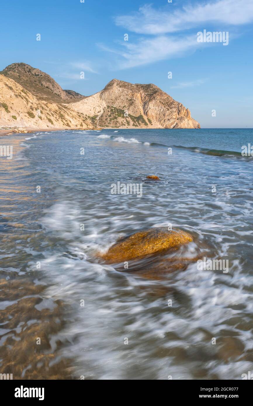 Rocks in the water, sandy beach with rocky cliffs, Paralia Paradisos ...