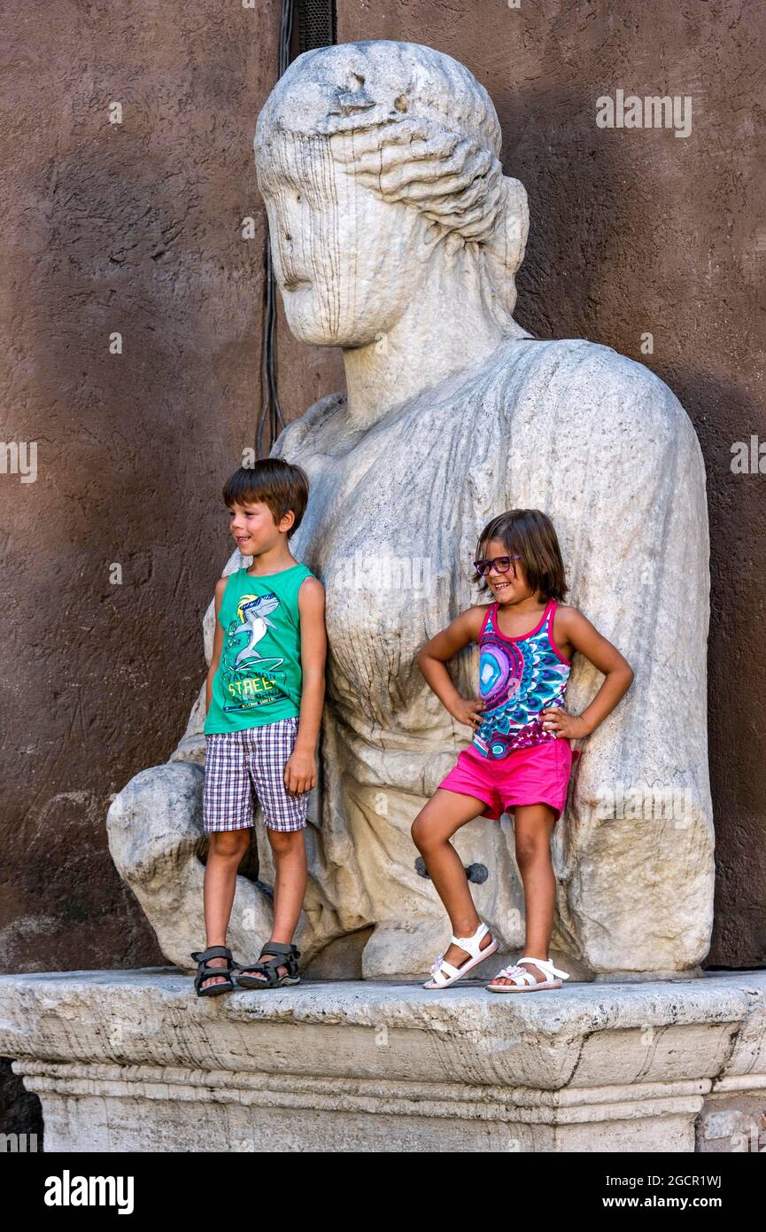Children posing at the ancient Roman colossal statue Madama Lucrezia ...