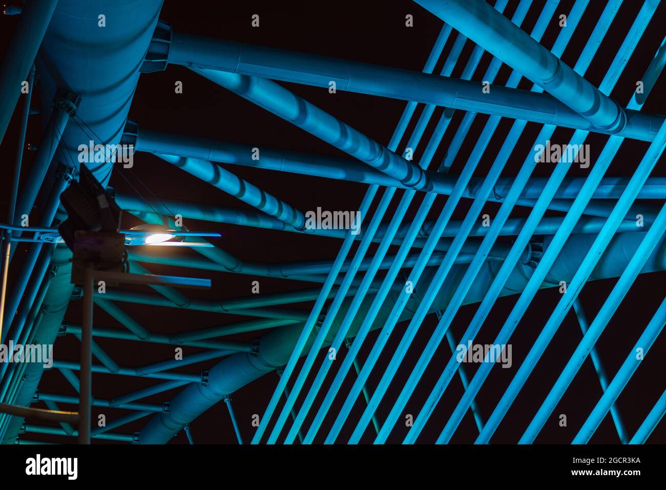 The illuminated structure of the Seri Saujana Bridge at night. One of ...