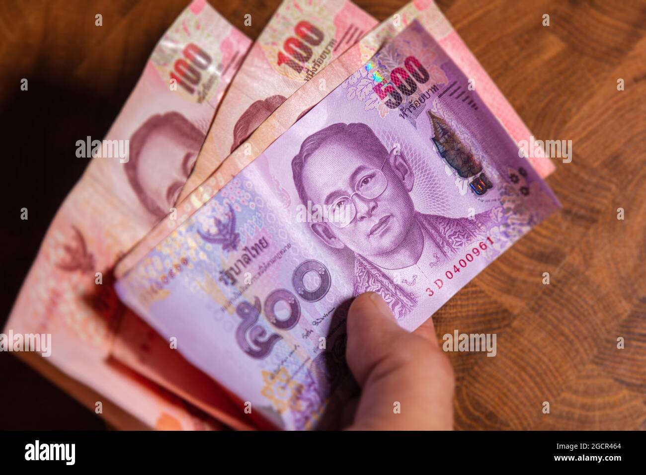 Man hand flip thai baht banknote, the official currency of Thailand. On ...