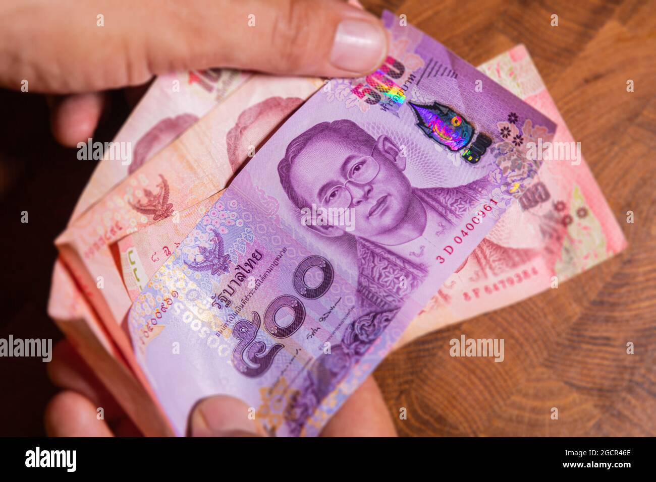 Man hand flip thai baht banknote, the official currency of Thailand. On ...