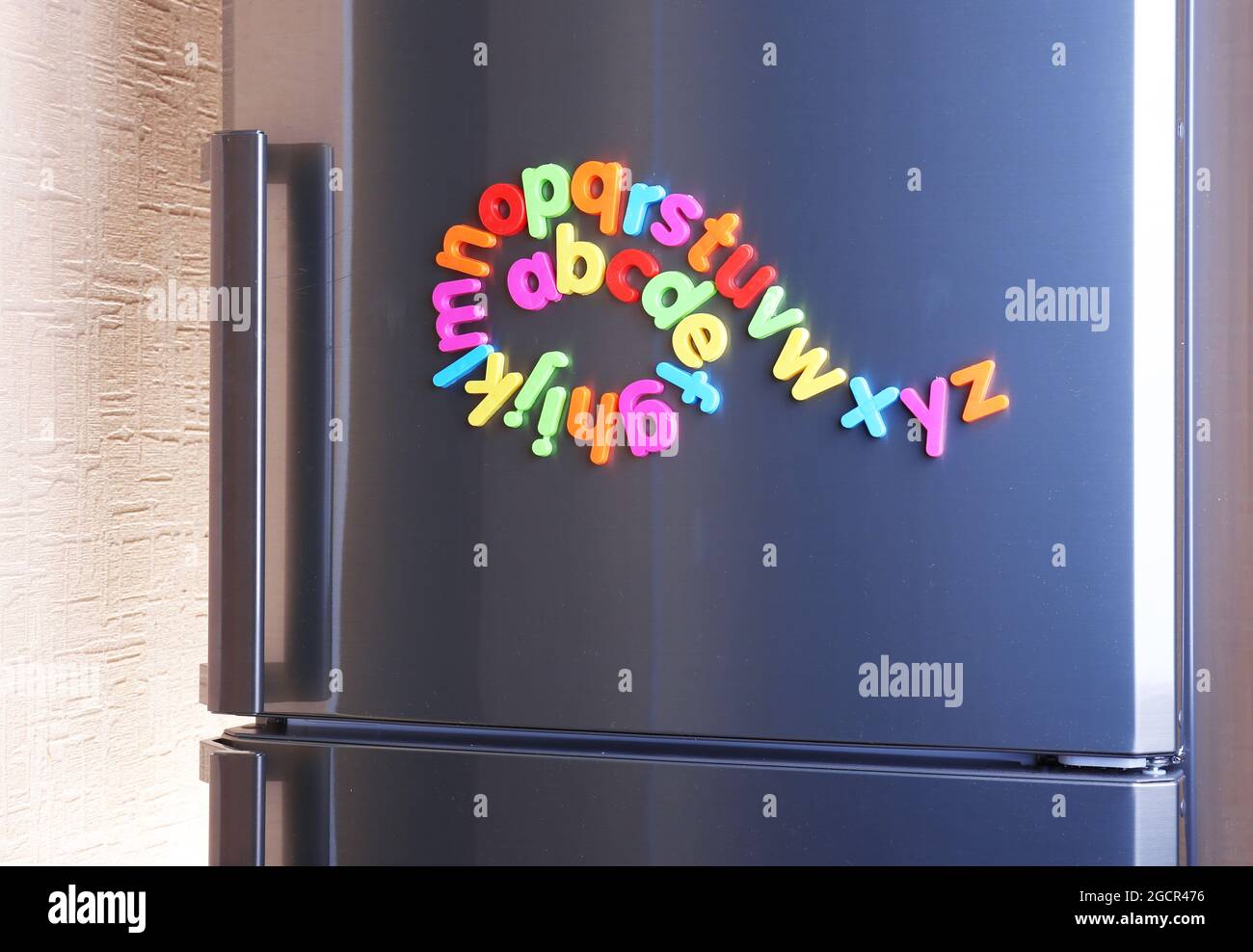 Colorful magnetic letters on refrigerator Stock Photo - Alamy