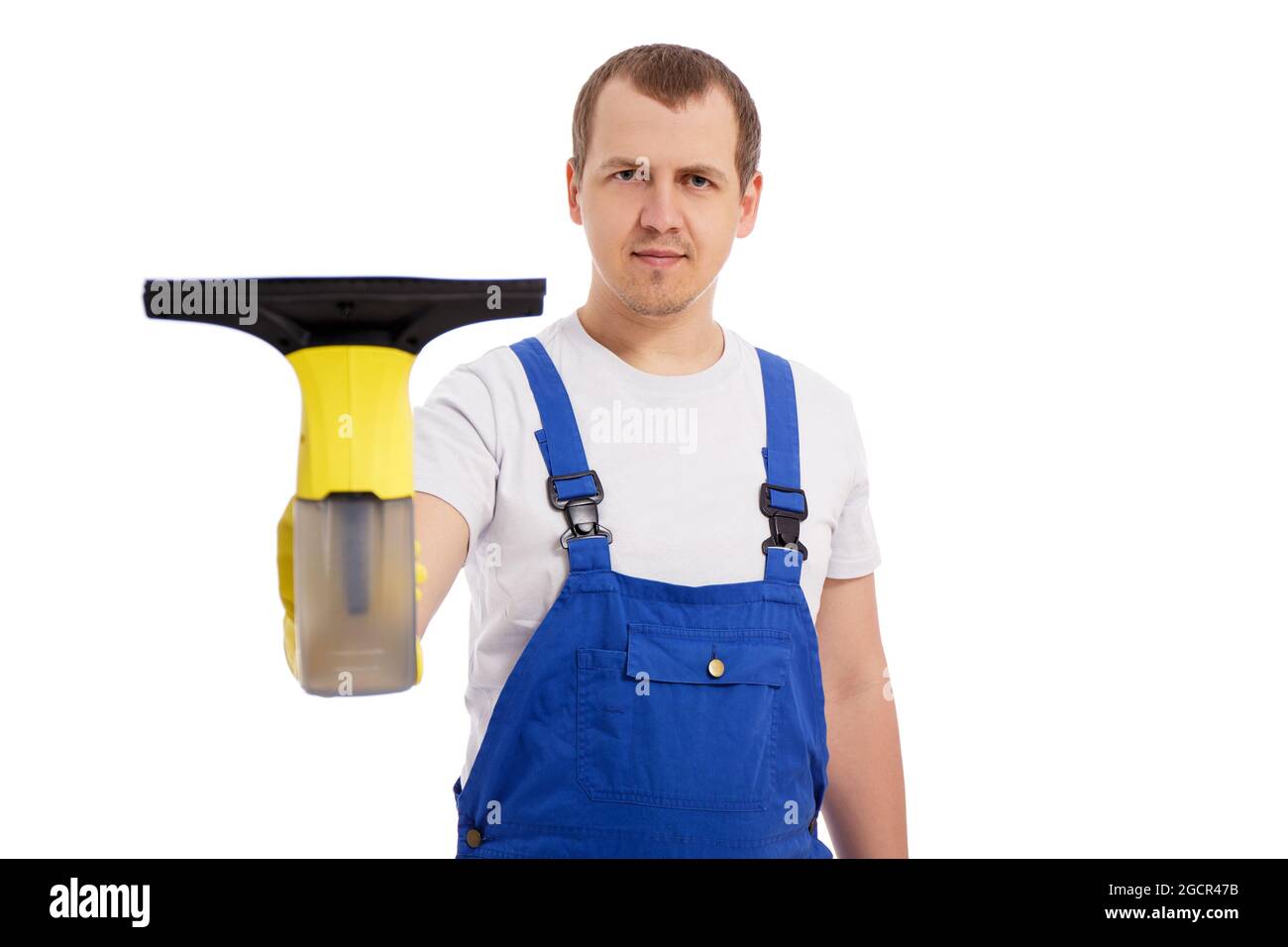 portrait of handsome man cleaner in uniform cleaning window with ...