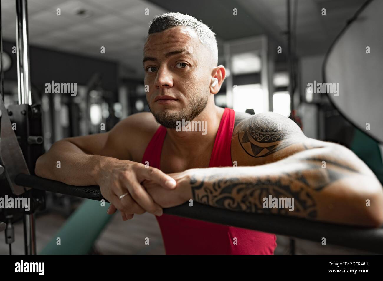 Portrait of man bodybuilder in red shirt in gym Stock Photo - Alamy