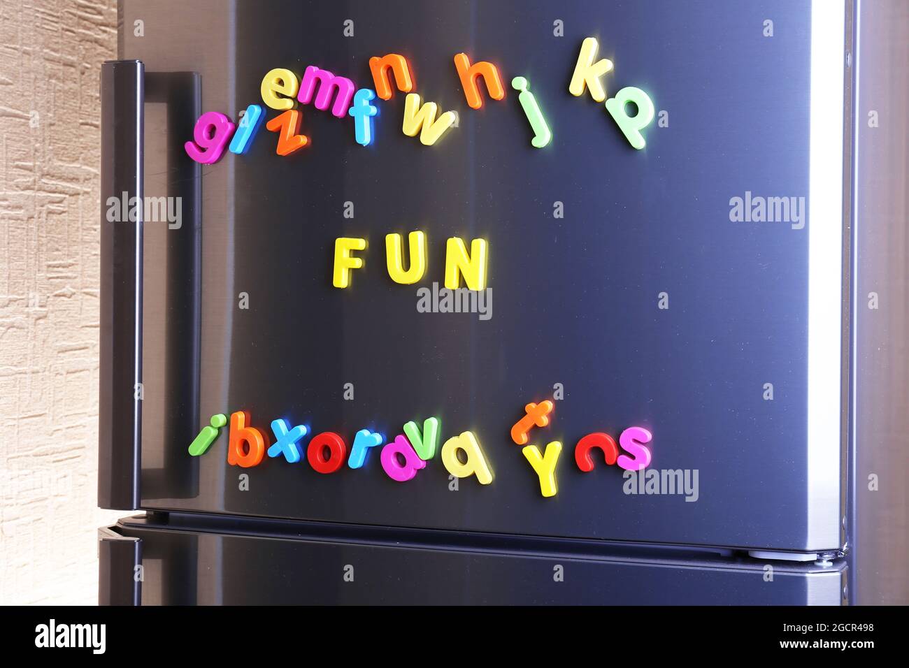 Word Fun spelled out using colorful magnetic letters on refrigerator ...