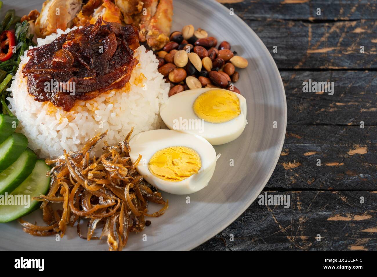 Nasi Lemak is a rice dish infused with coconut cream and laden with ...