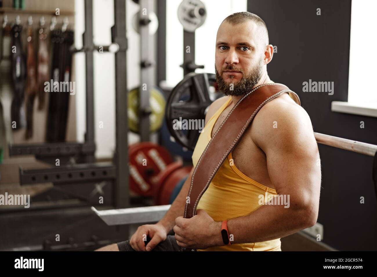 Strong bodybuilder with muscular chest and shoulders in gym Stock Photo ...