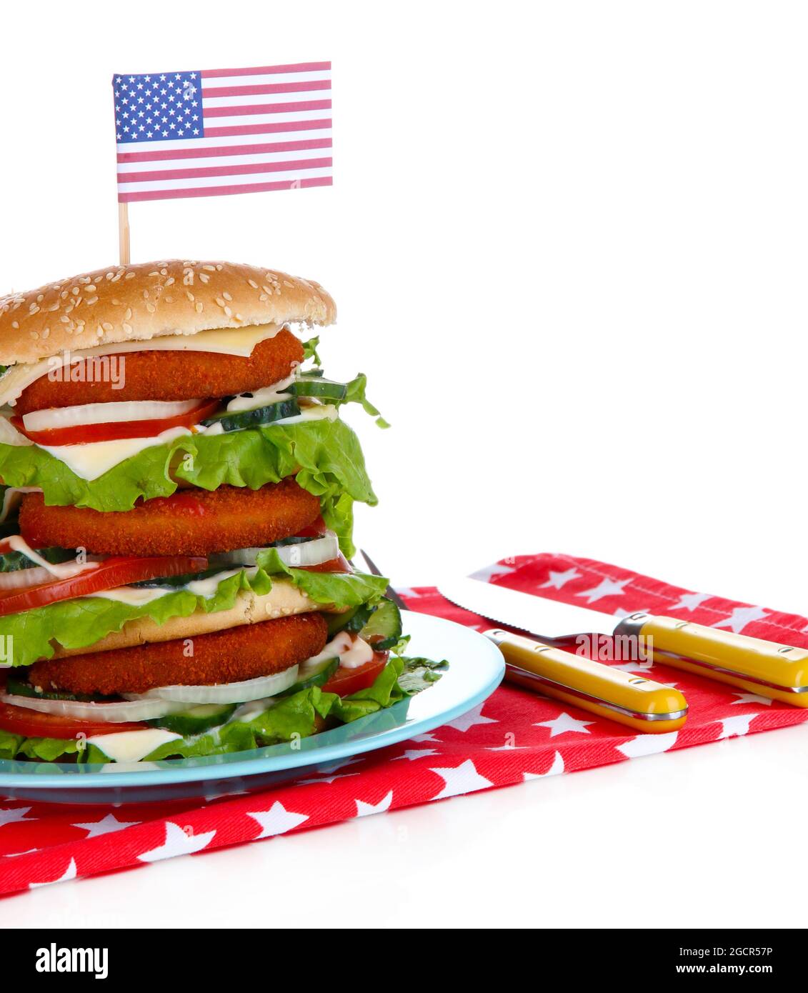 Composition with huge burger on color plate and USA flag, isolated on ...