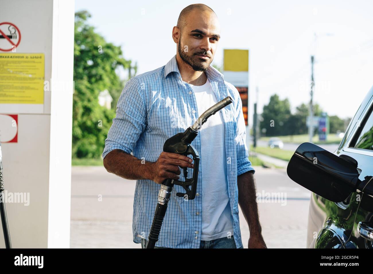 Man filling gasoline fuel in car at gas station Stock Photo - Alamy