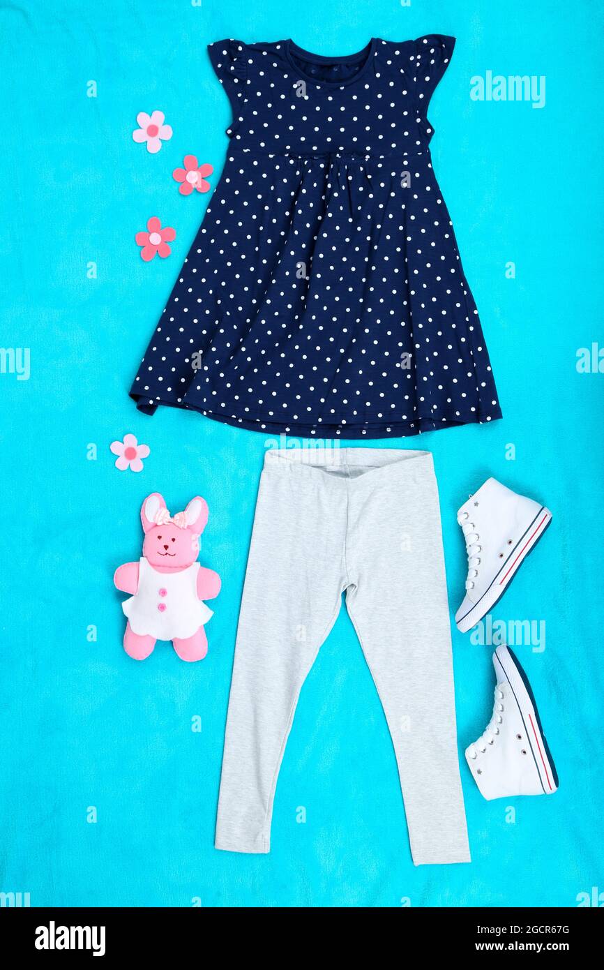 Beautiful clothes for little girl on blue background Stock Photo - Alamy