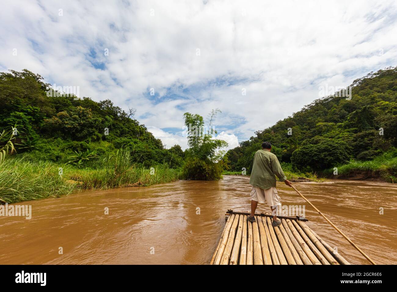 Men on a wooden or bamboo raft on the Mae Taeng river near Chiang Mai ...