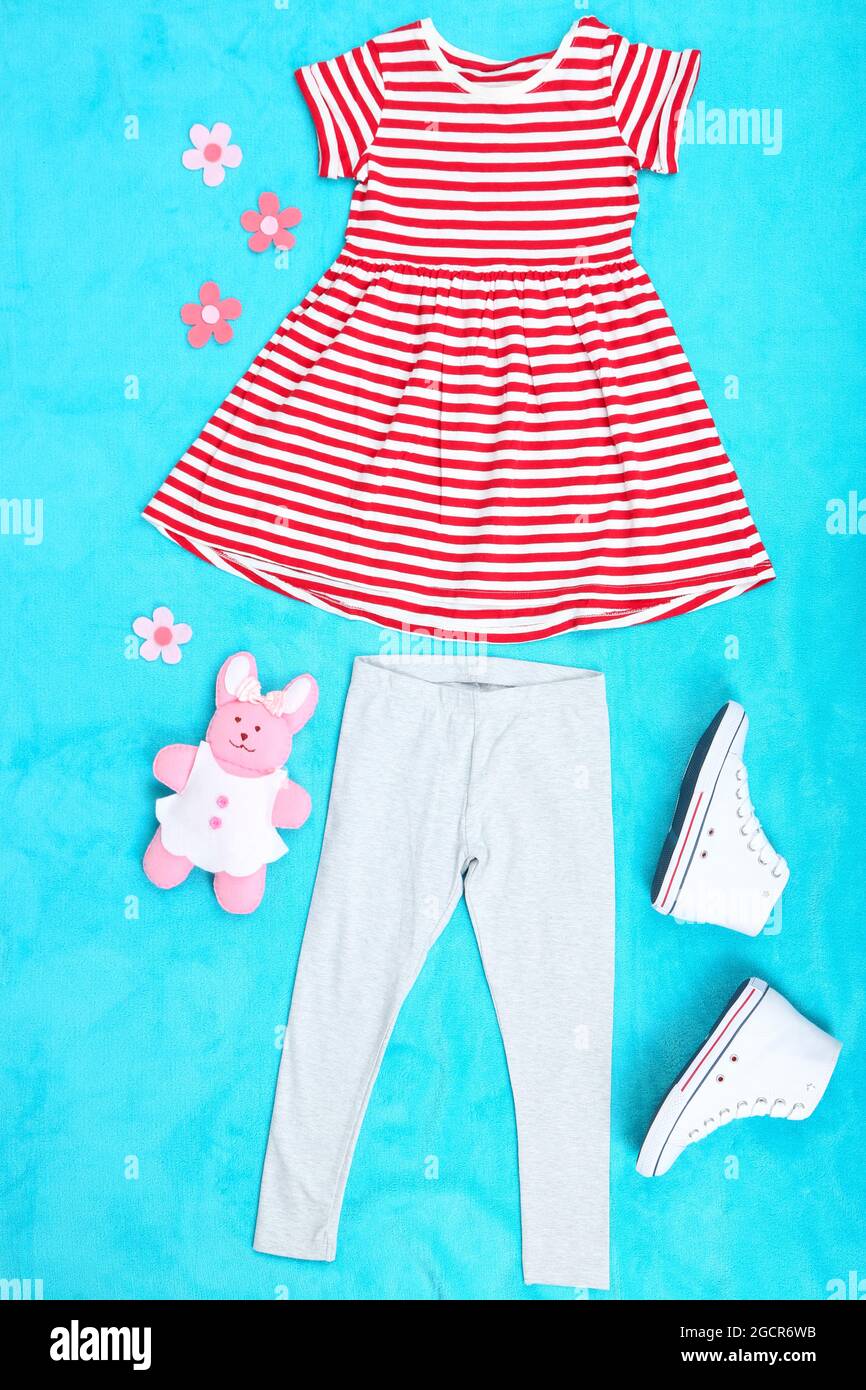 Beautiful clothes for little girl on blue background Stock Photo - Alamy